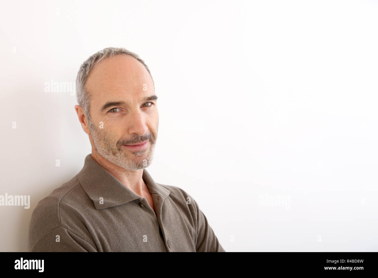 Portrait of 50-year-old man standing on white background Stock Photo ...