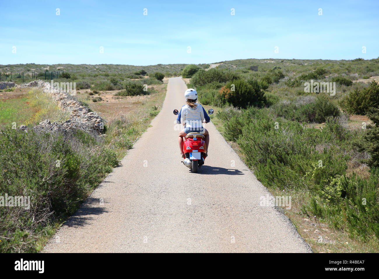 Back view of couple riding moto in natural landscape Stock Photo - Alamy