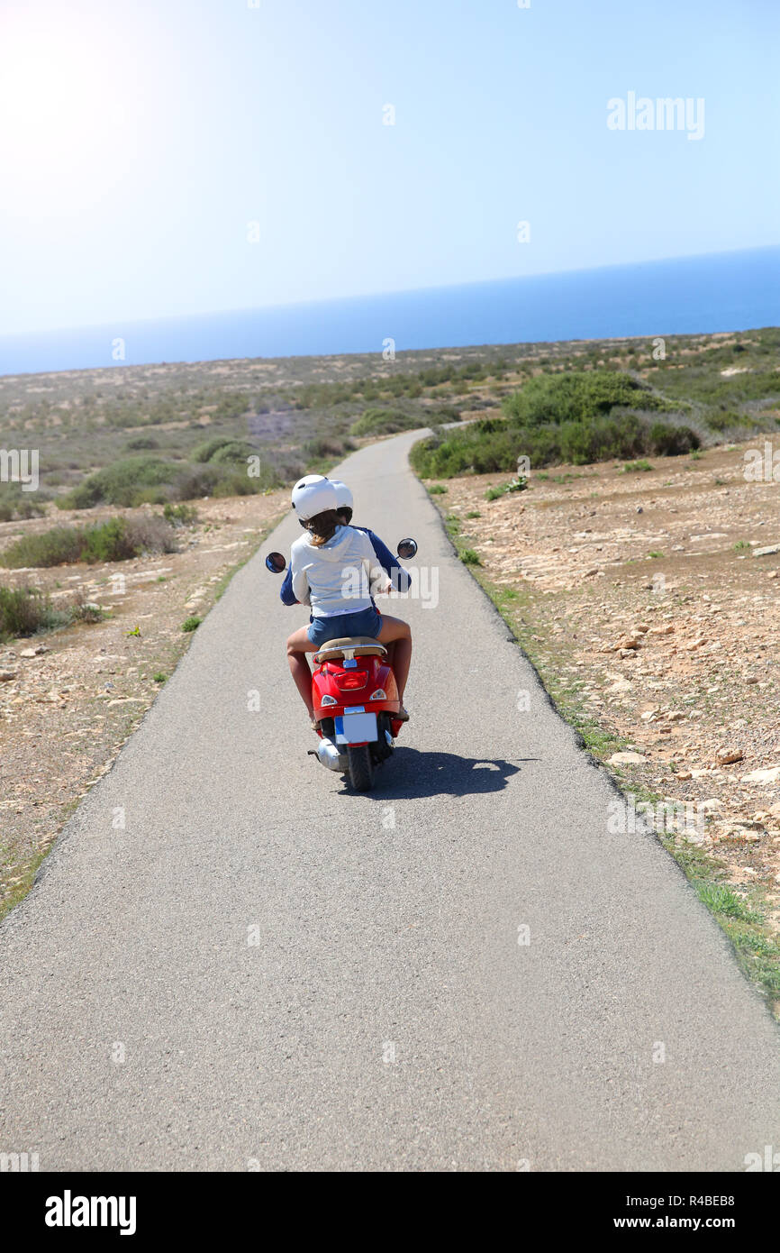 Back view of couple riding moto in natural landscape Stock Photo - Alamy