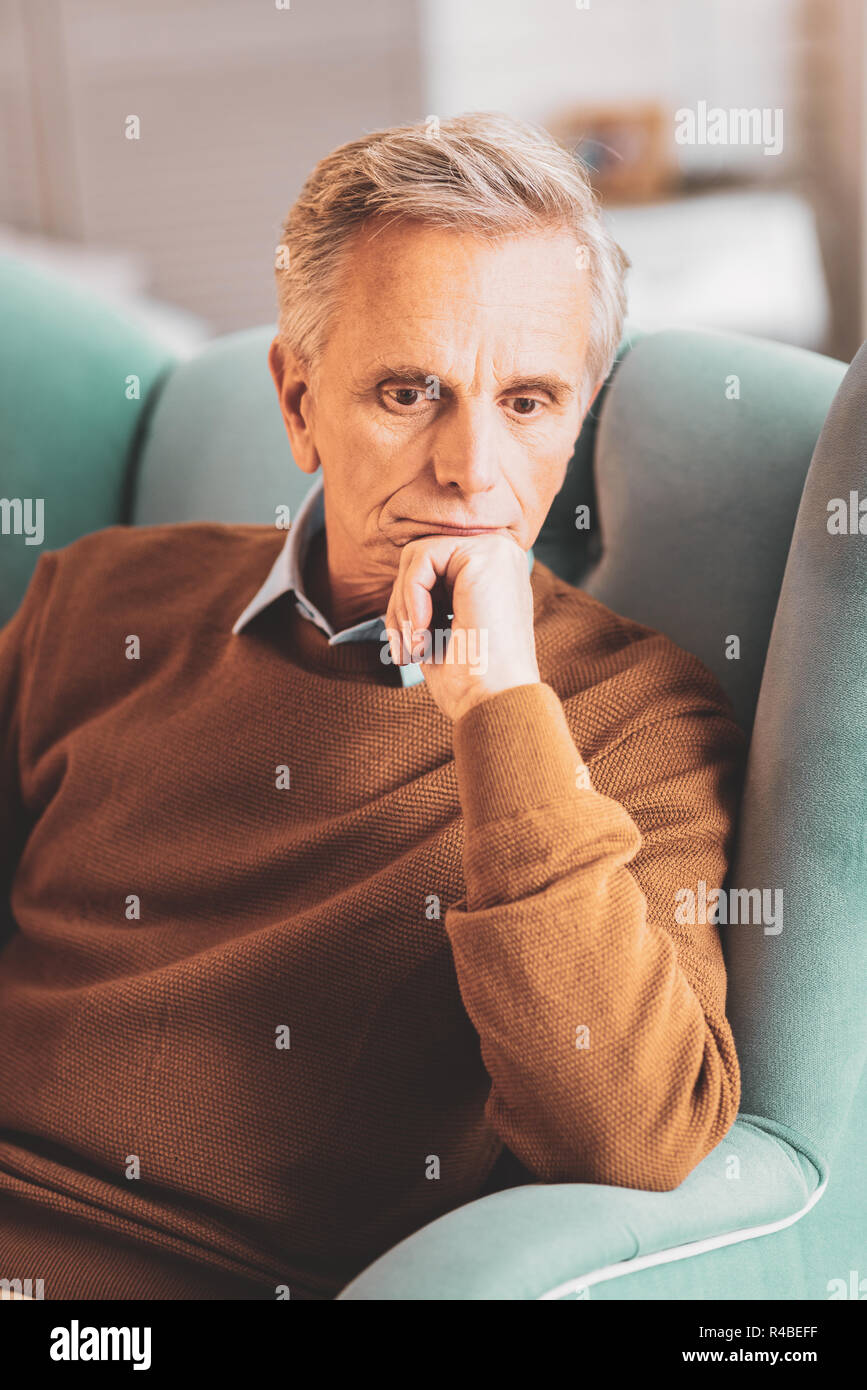Introspective man. Aged introspective man feeling thoughtful while ...