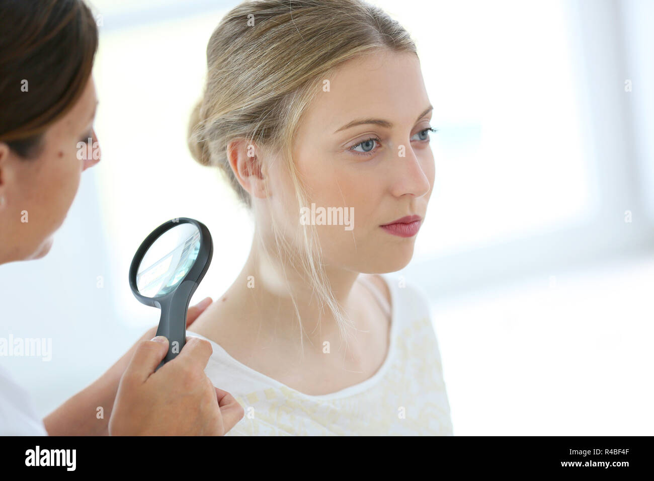 Young woman seeing doctor for dermatological control Stock Photo - Alamy