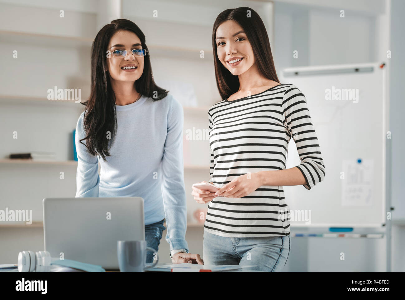 Sister visit. Appealing smiling woman wearing striped shirt feeling ...