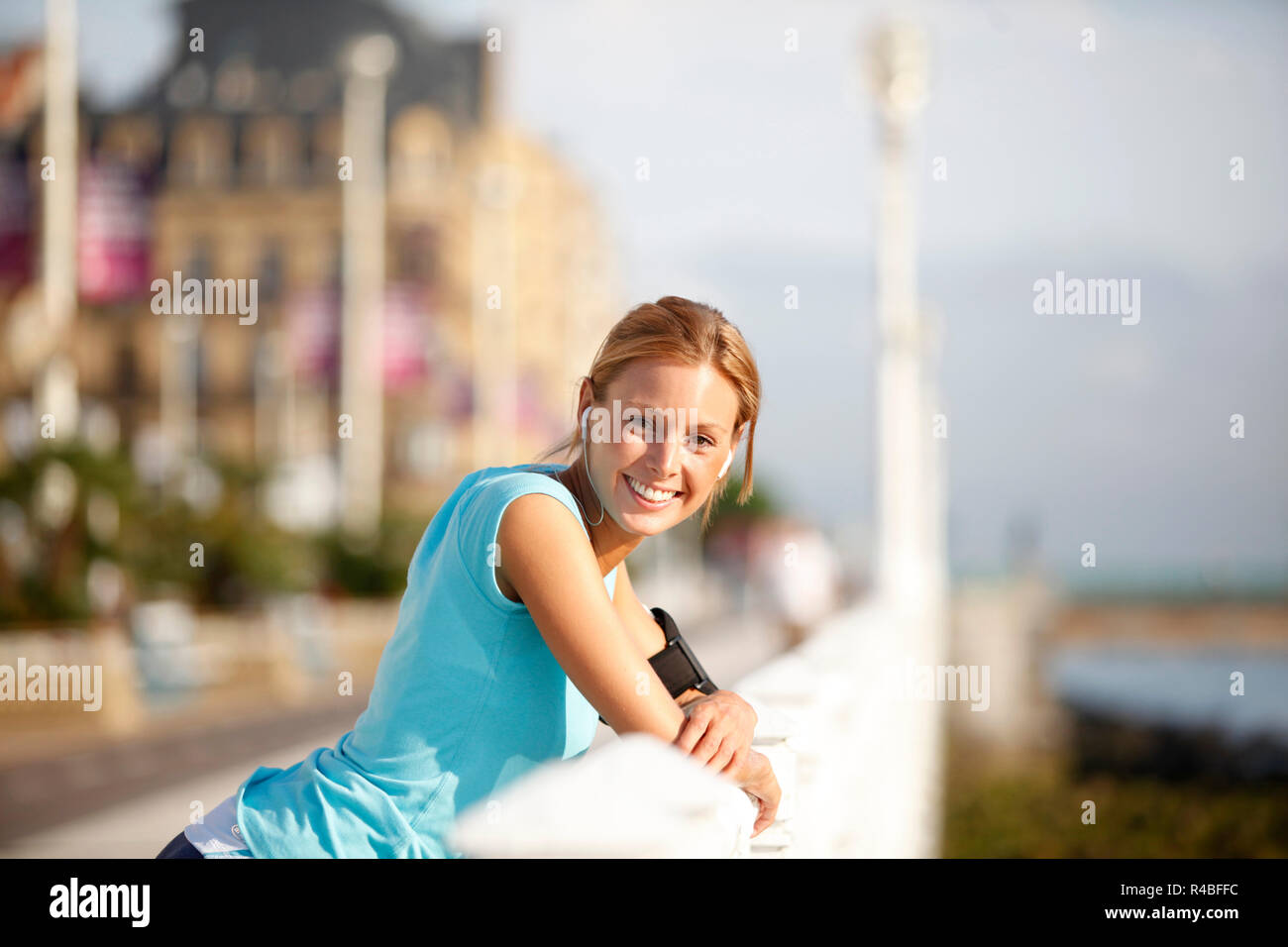 Cheerful jogger relaxing after running in town Stock Photo - Alamy