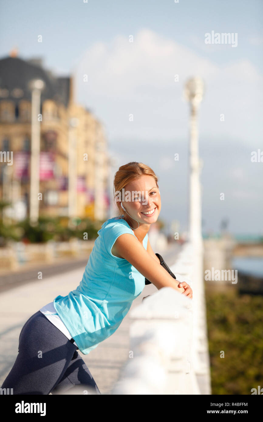 Cheerful jogger relaxing after running in town Stock Photo - Alamy