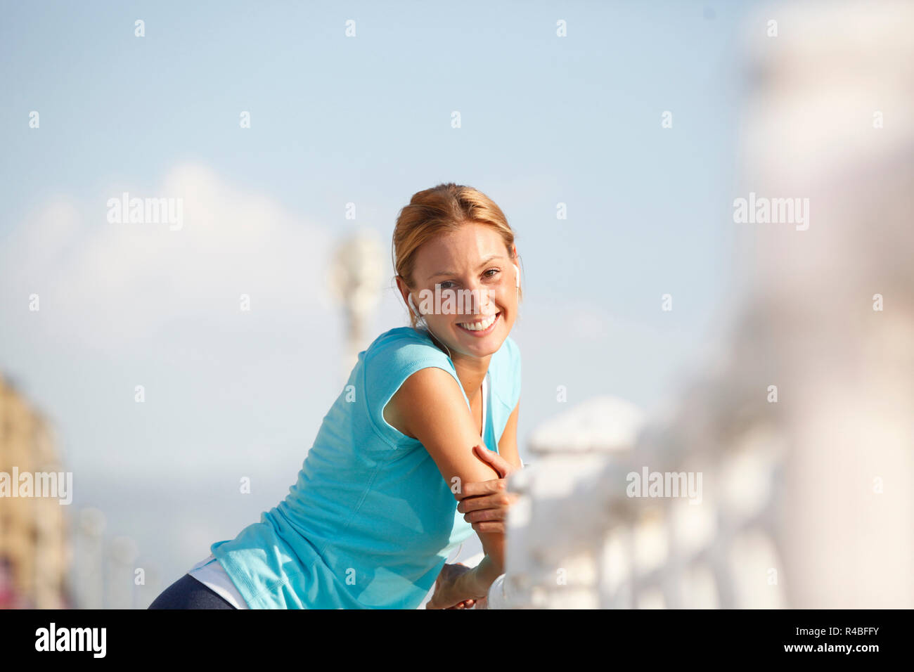 Cheerful jogger relaxing after running in town Stock Photo - Alamy