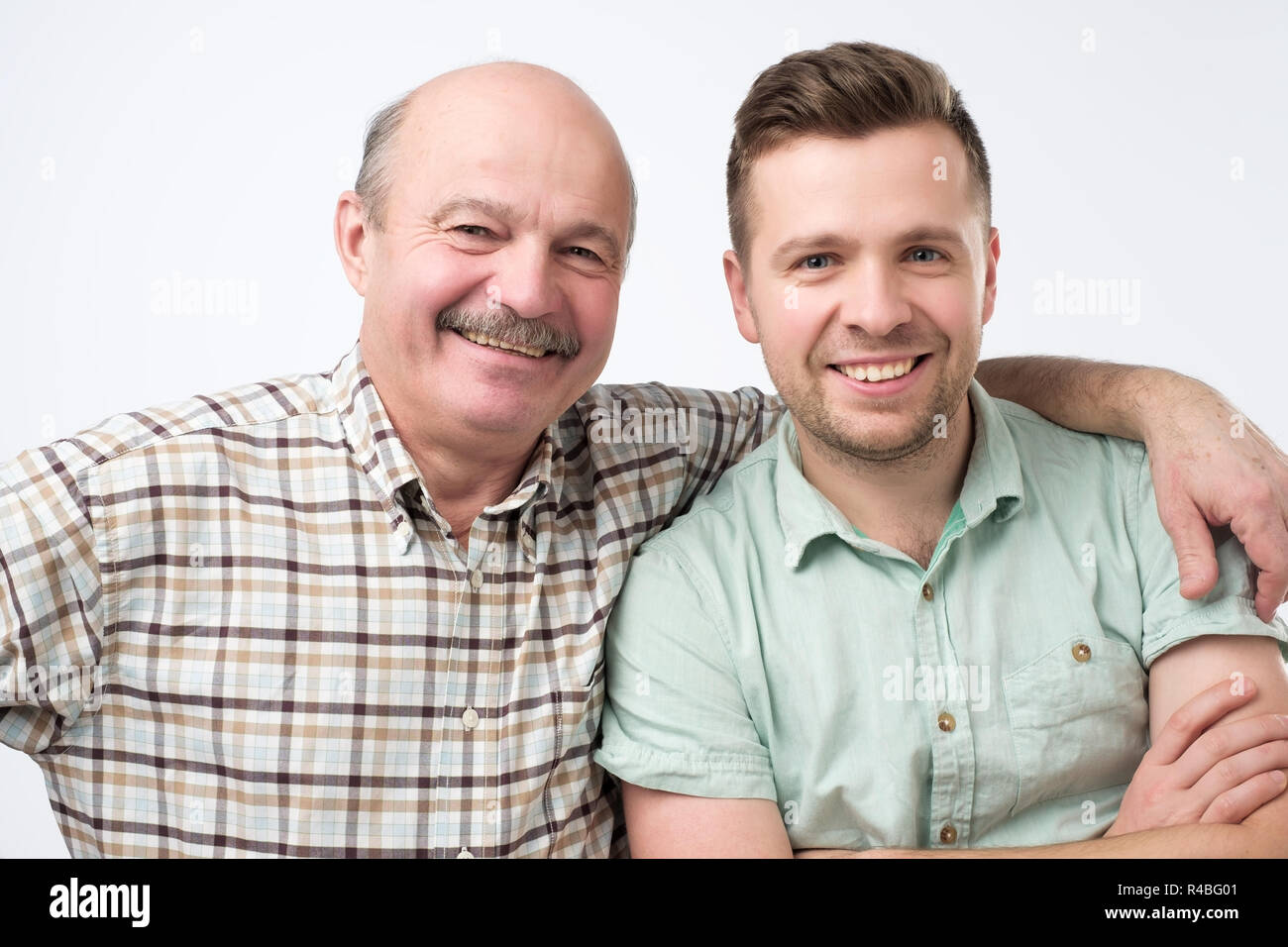Father and son standing together and smiling Stock Photo - Alamy