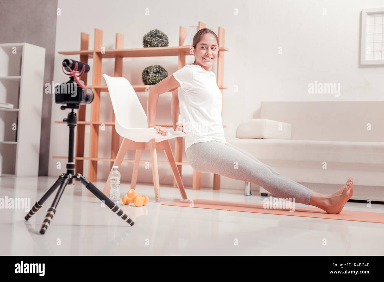 Sporty people. Beautiful young woman smiling while exercising Stock ...