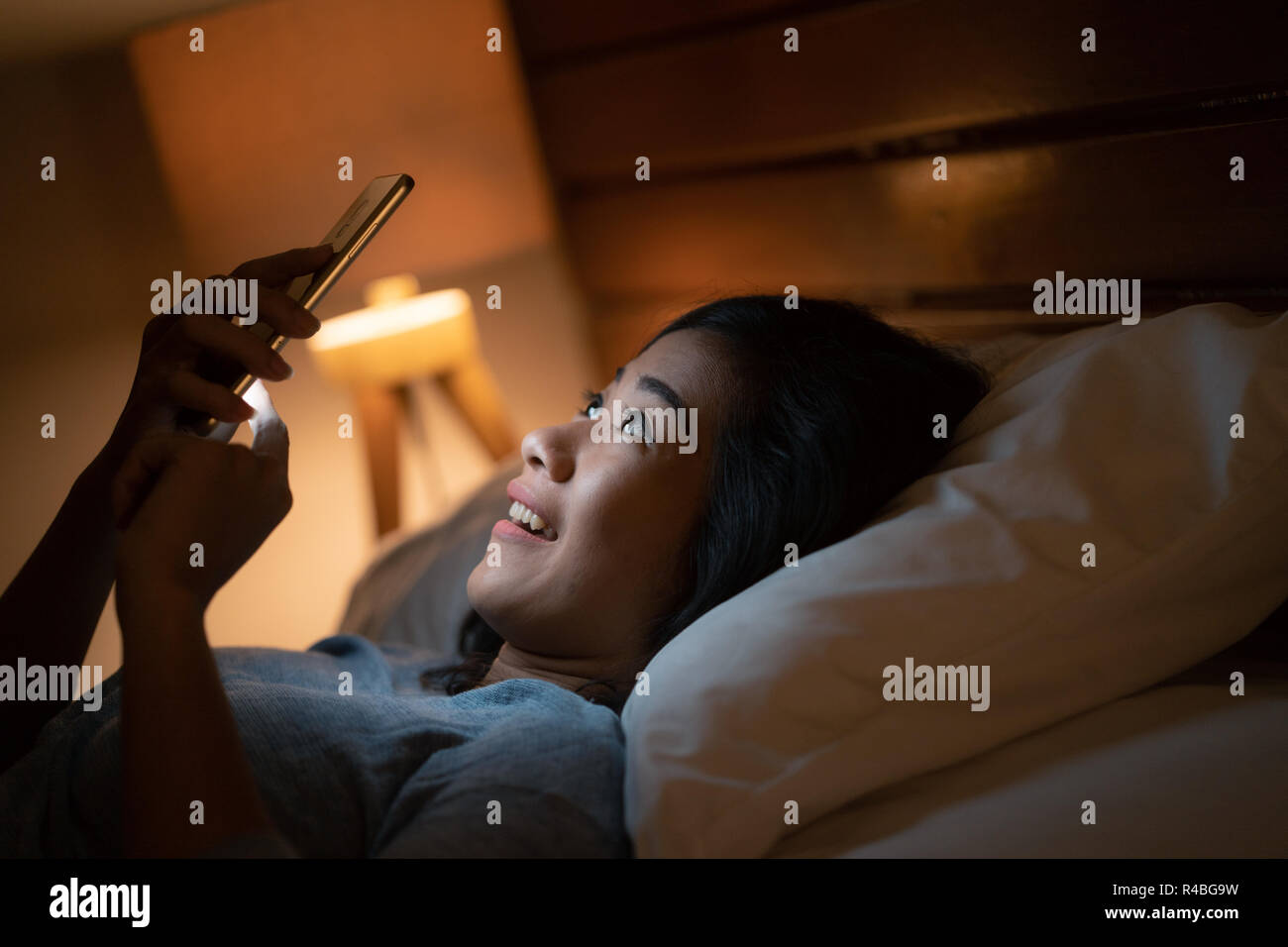 happy social media user using phone Stock Photo - Alamy
