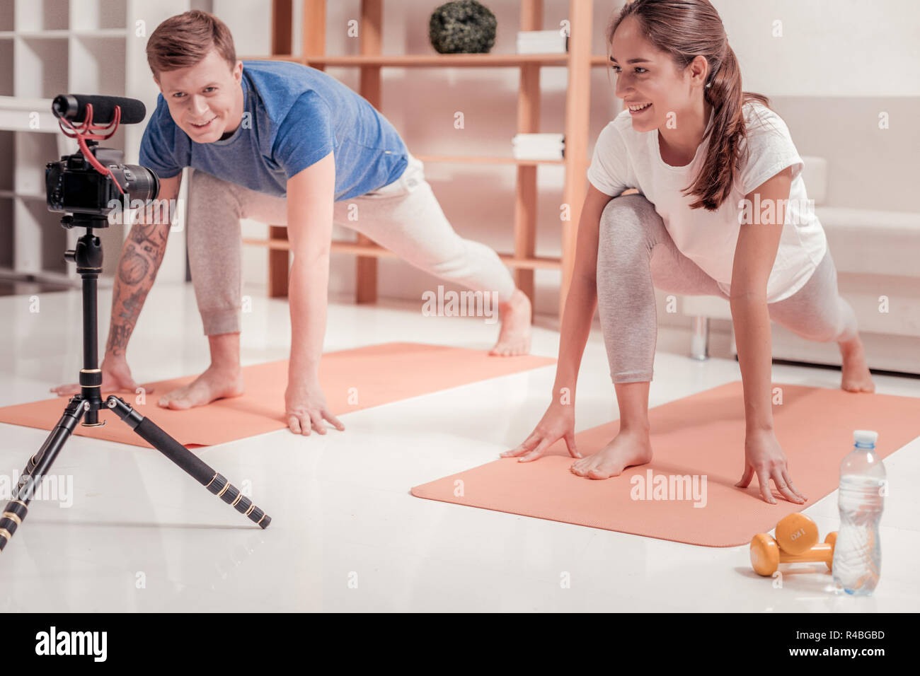 Lets train. Motivated man and woman smiling while having a training ...