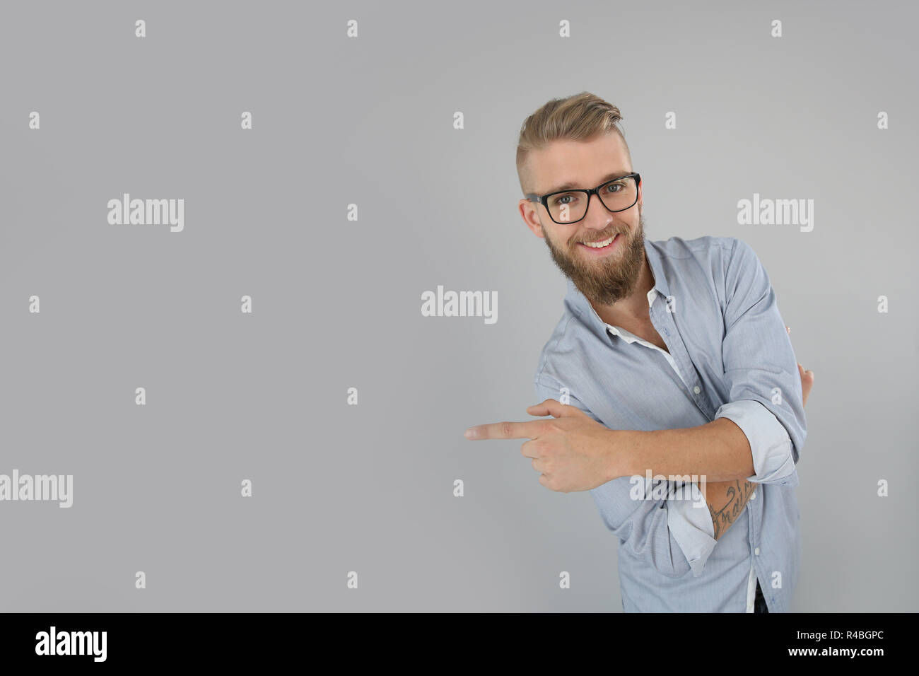 Trendy guy pointing at message, isolated Stock Photo - Alamy