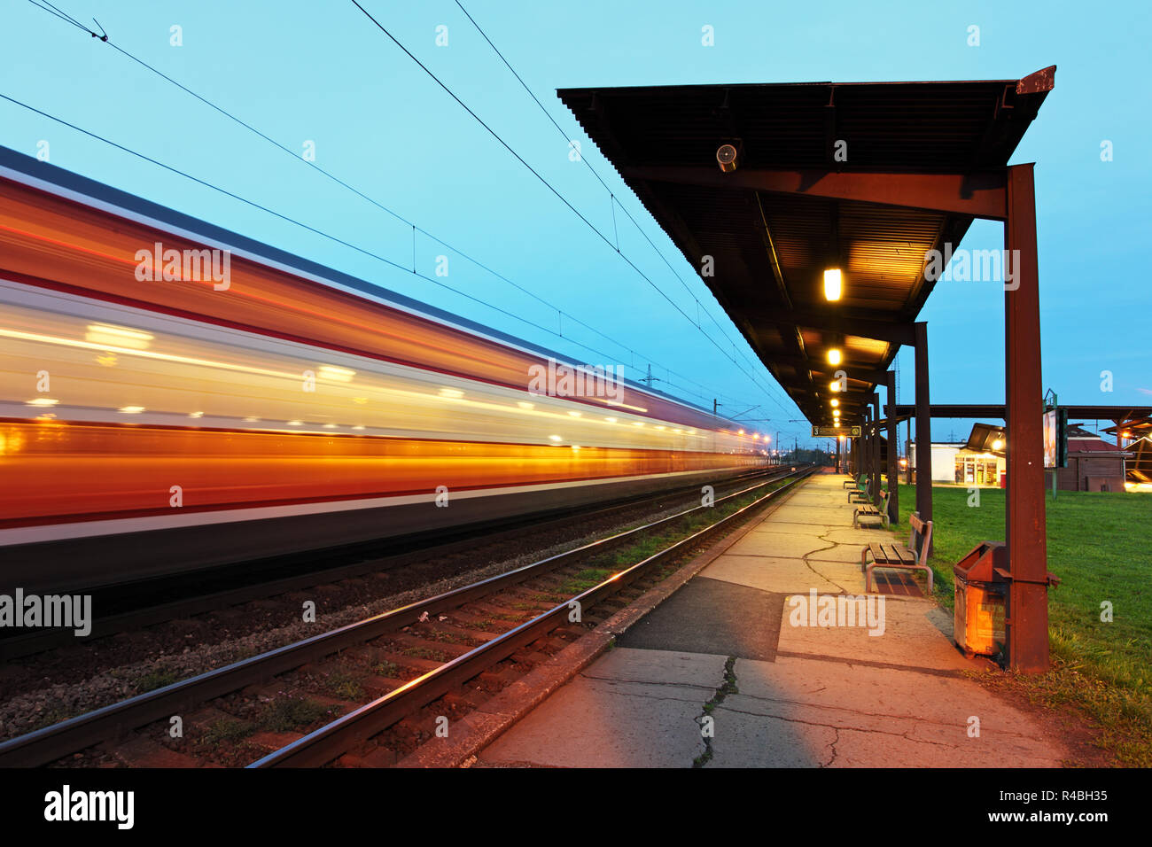 Passanger station with motion train at night Stock Photo - Alamy