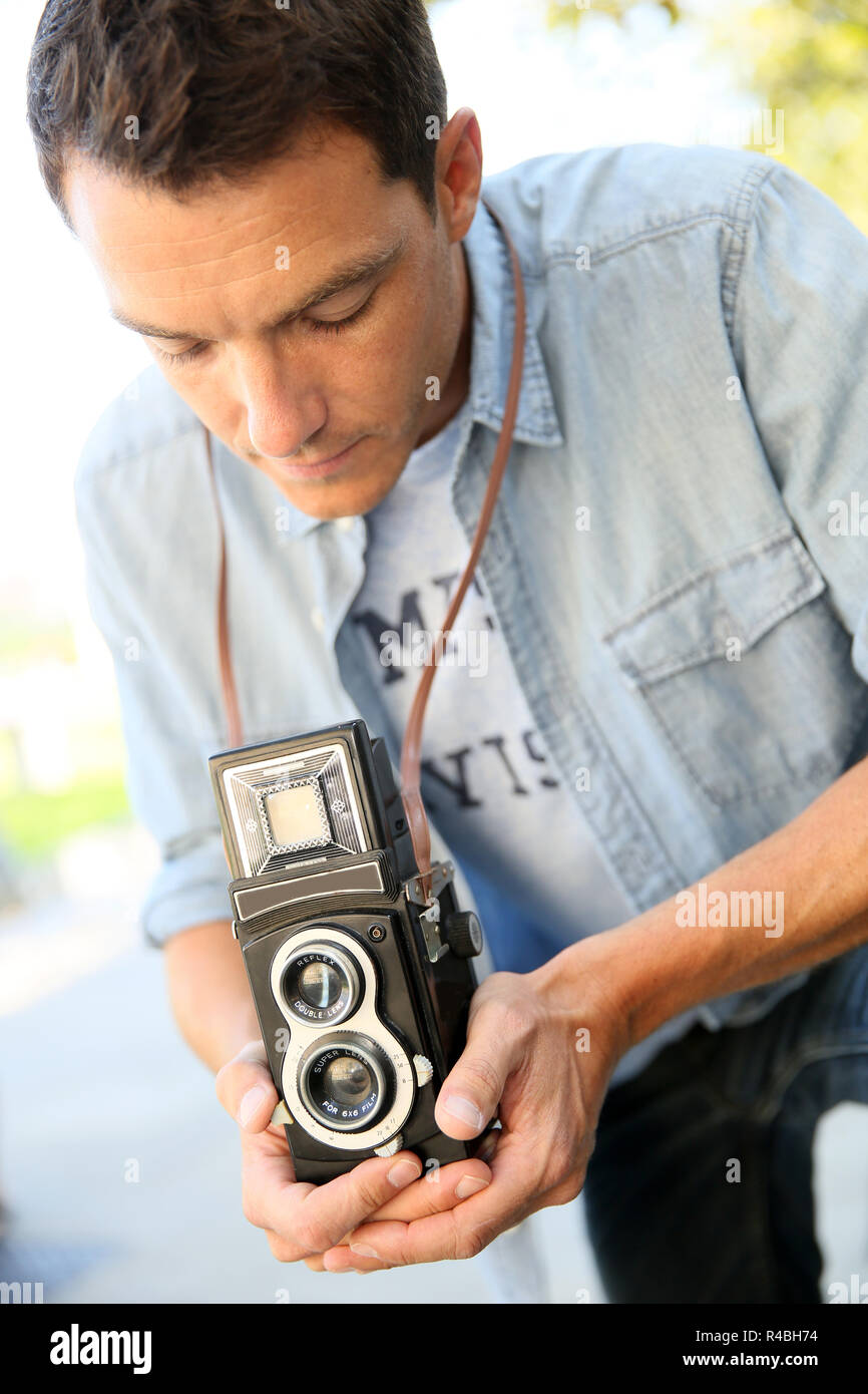 Photographer using vintage camera Stock Photo - Alamy