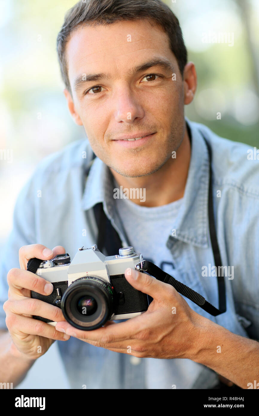 Photographer shooting outside with old camera Stock Photo - Alamy