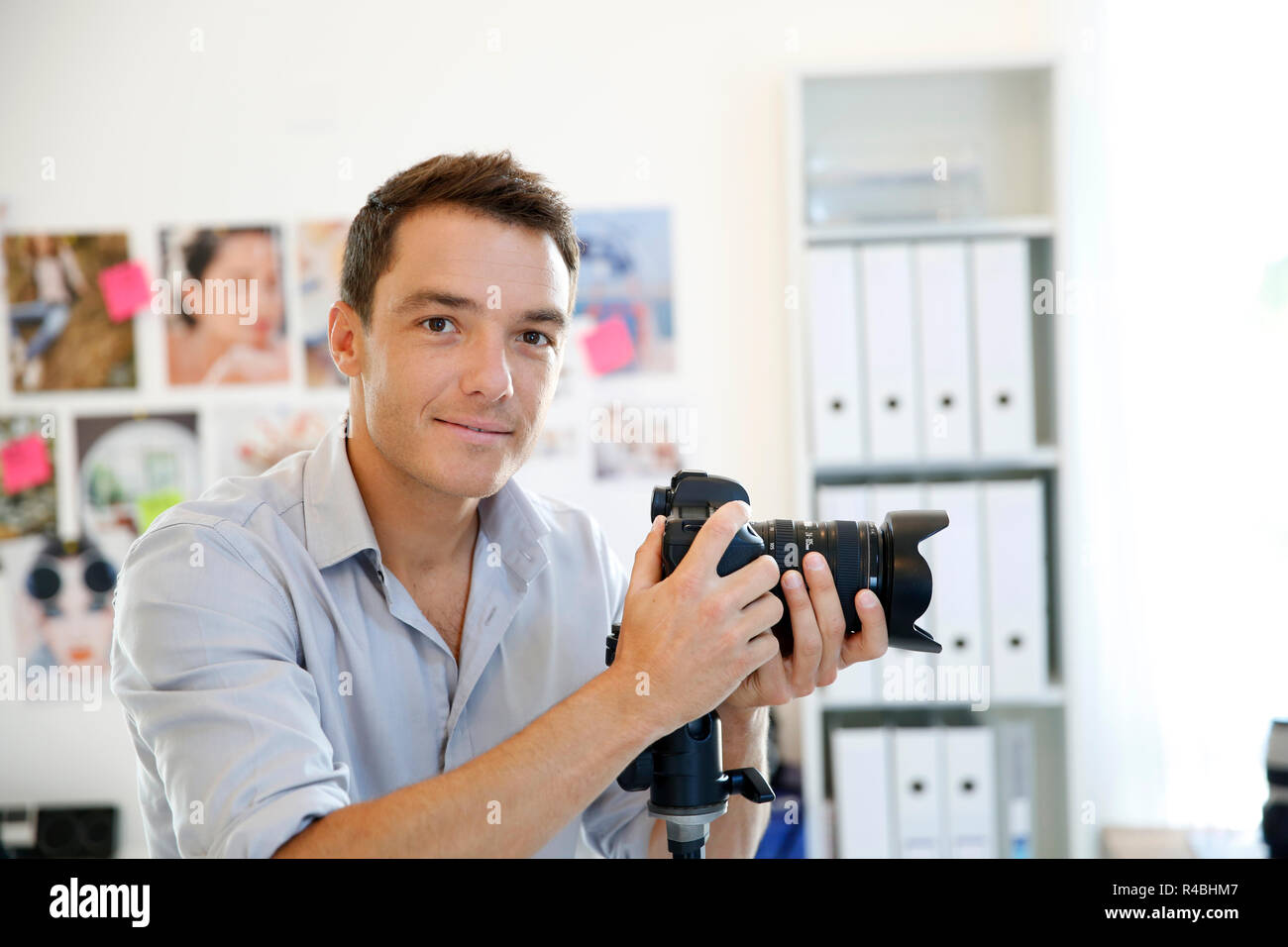 Photographer working in photo agency Stock Photo - Alamy