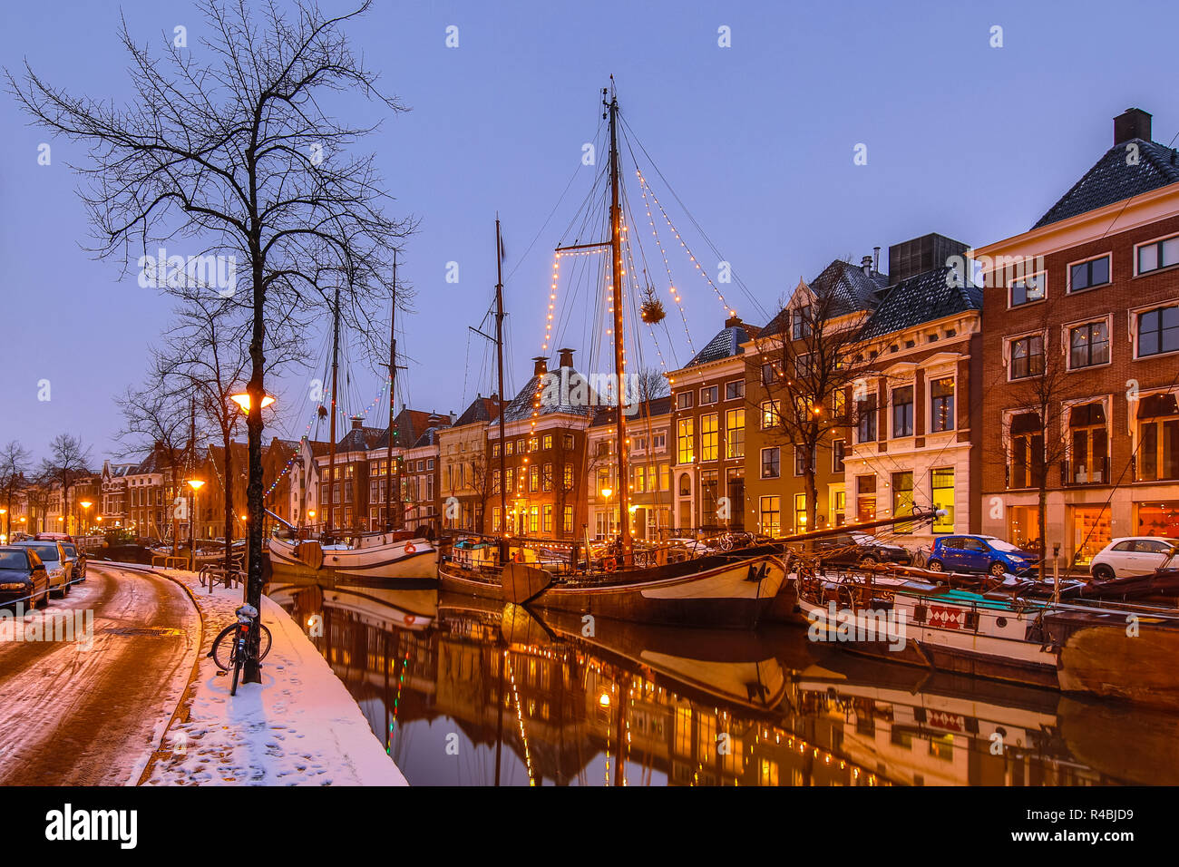 Historic buildings on snowy Hoge der Aa Quay with ship in Groningen ...