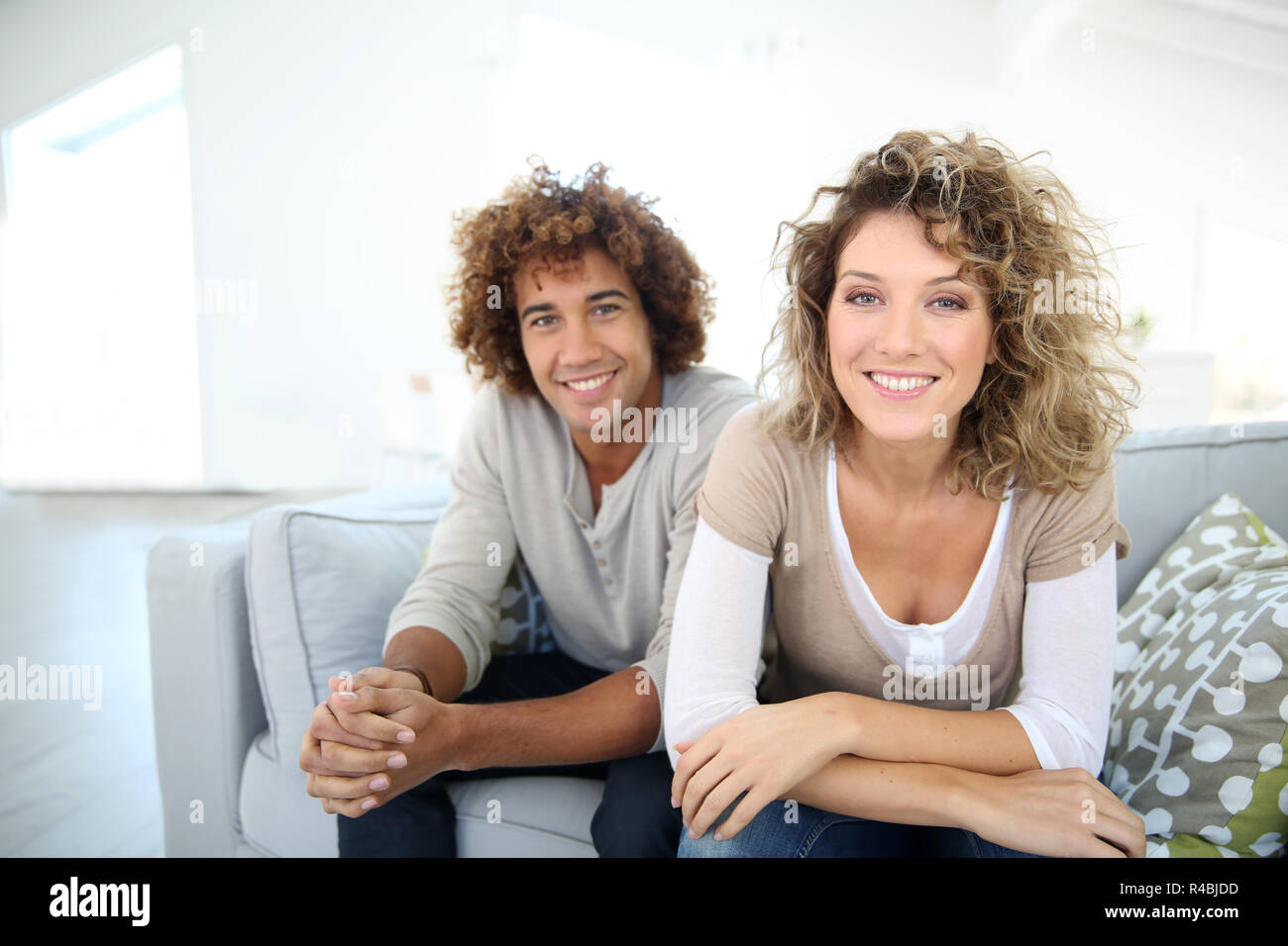Sweet couple relaxing at home in sofa Stock Photo - Alamy