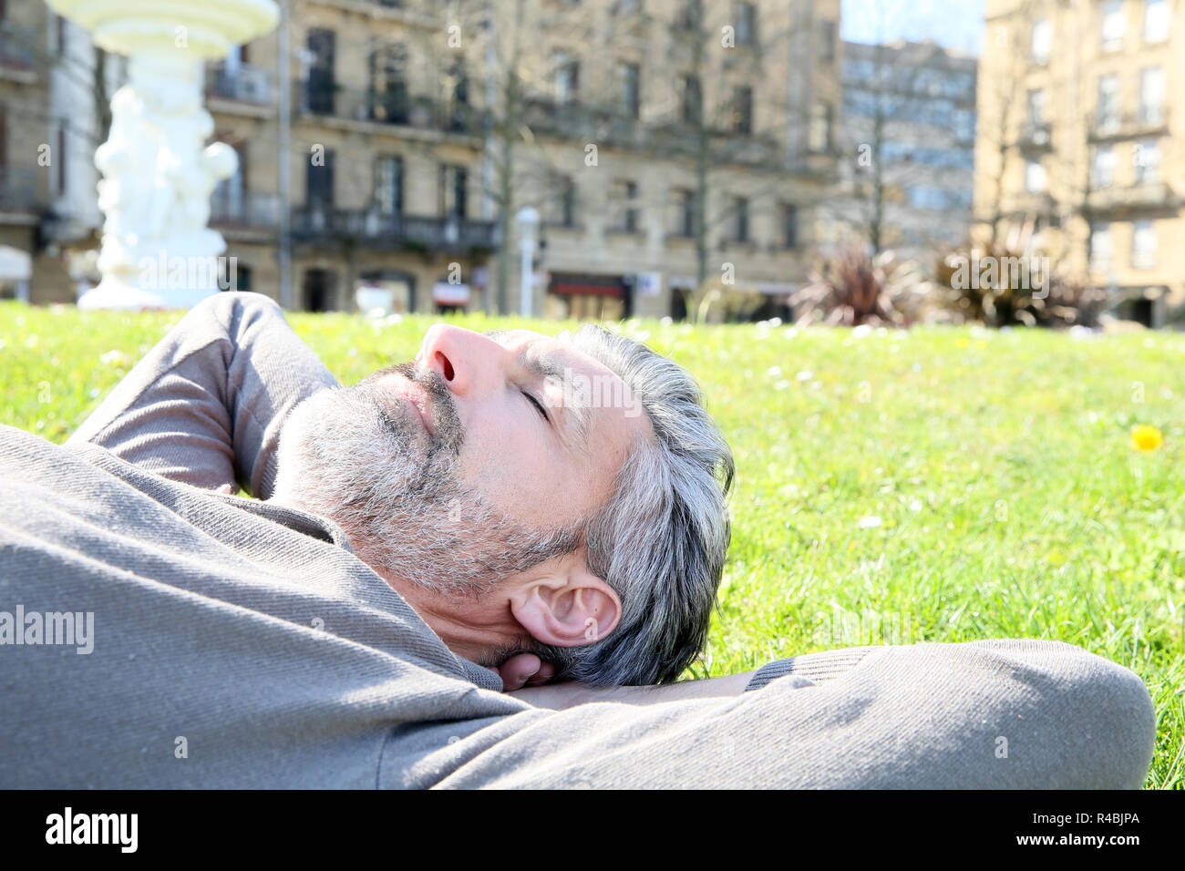 Man laying in urban park hi-res stock photography and images - Alamy