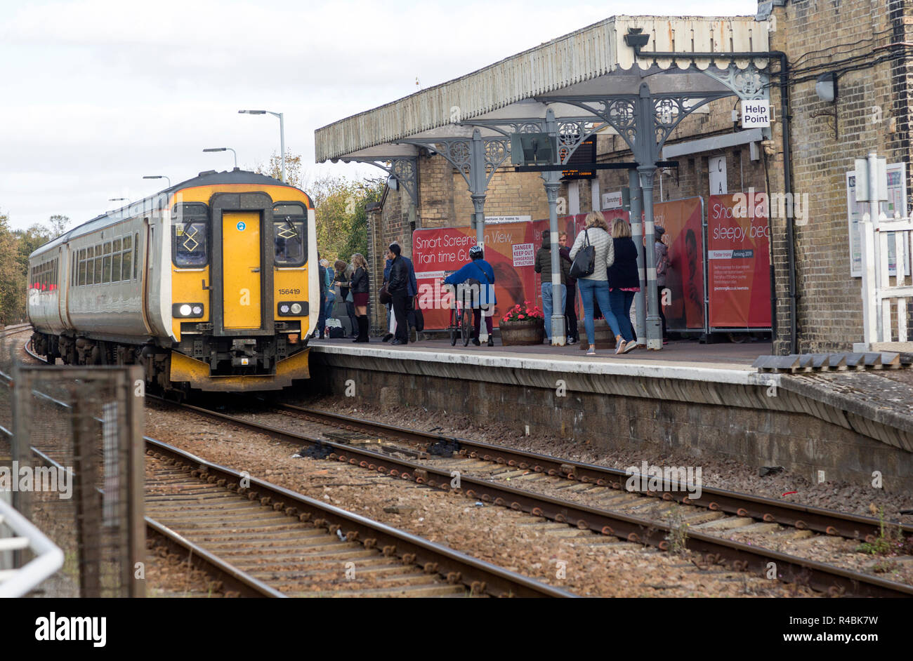 Passengers on platform train arriving, railway station, Saxmundham, Suffolk, England, UK British ...