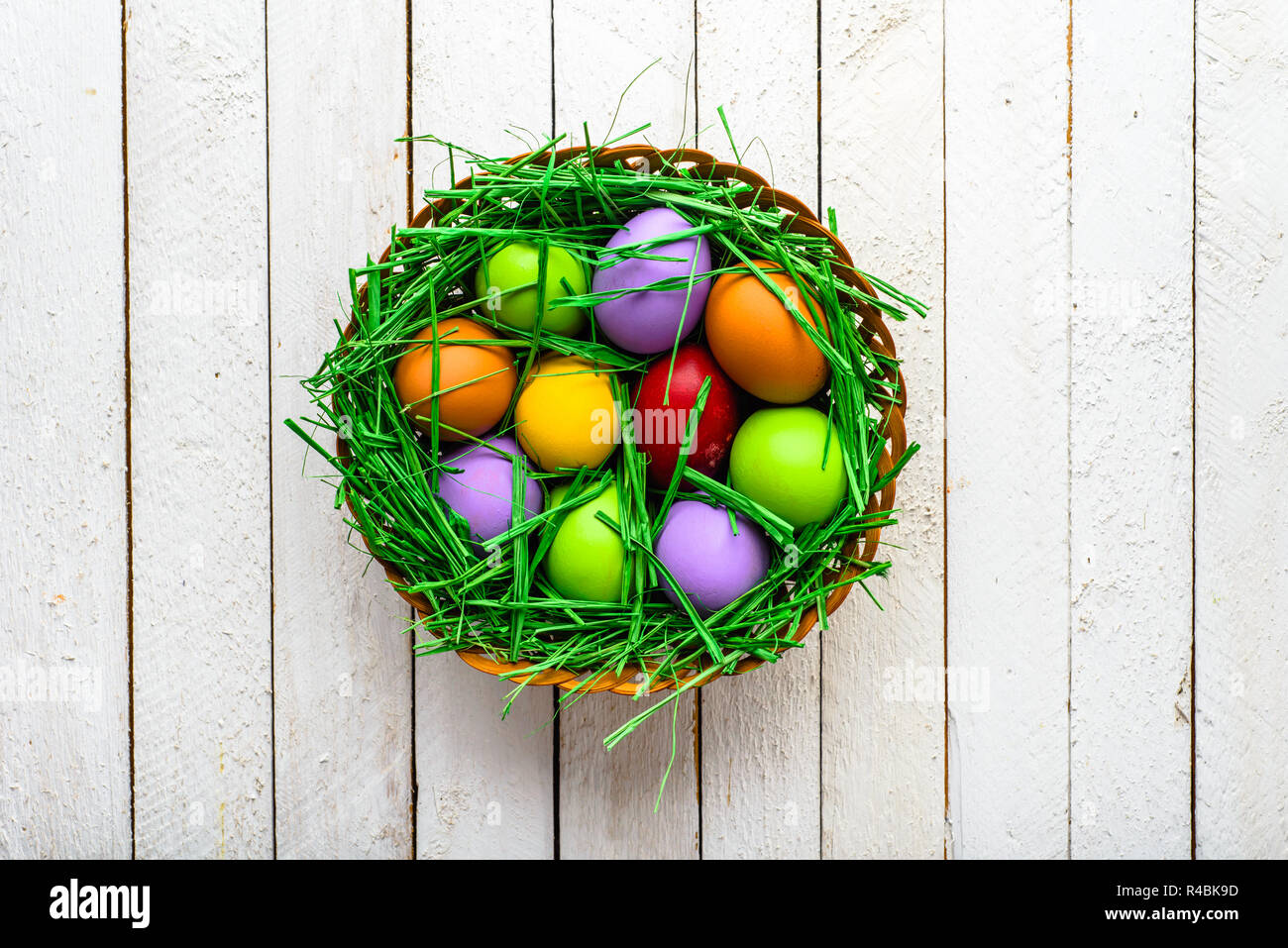 Wooden background with easter eggs in the basket, top view Stock Photo ...