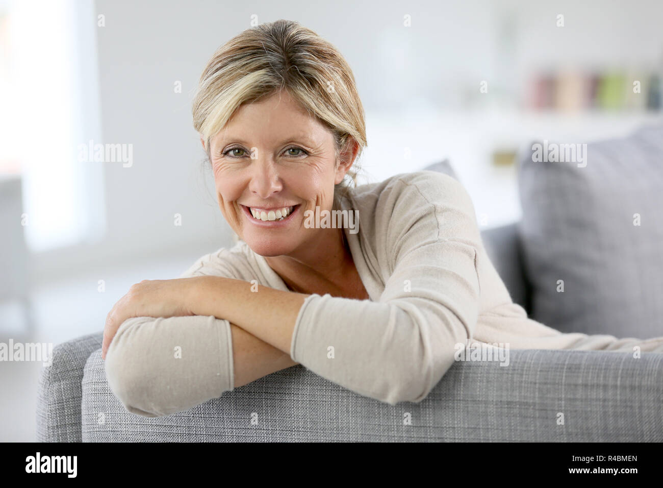 Beautiful 40-year-old woman relaxing in sofa Stock Photo - Alamy