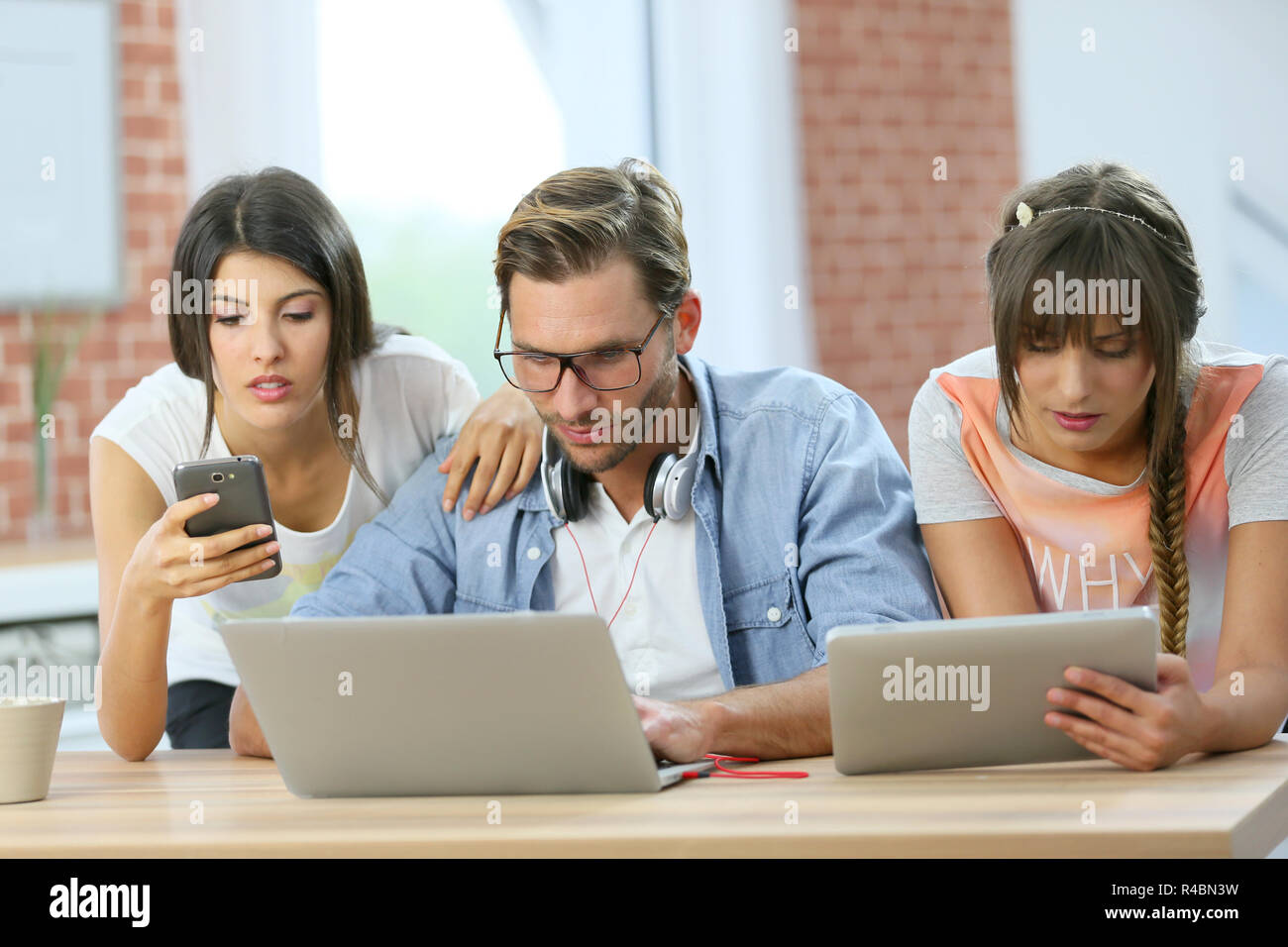 Group of friends connected together on laptop and tablet Stock Photo ...