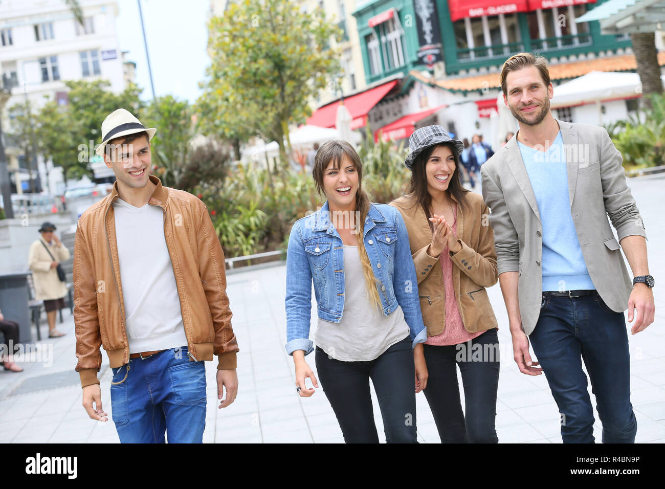 Group of friends walking in street and having fun Stock Photo - Alamy