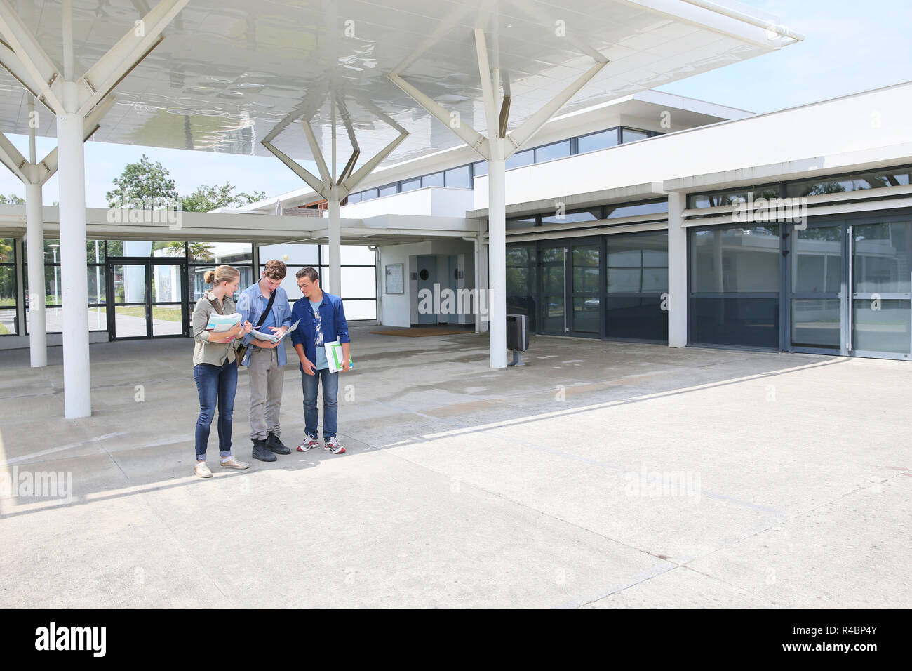 Group of students standing by school building Stock Photo - Alamy