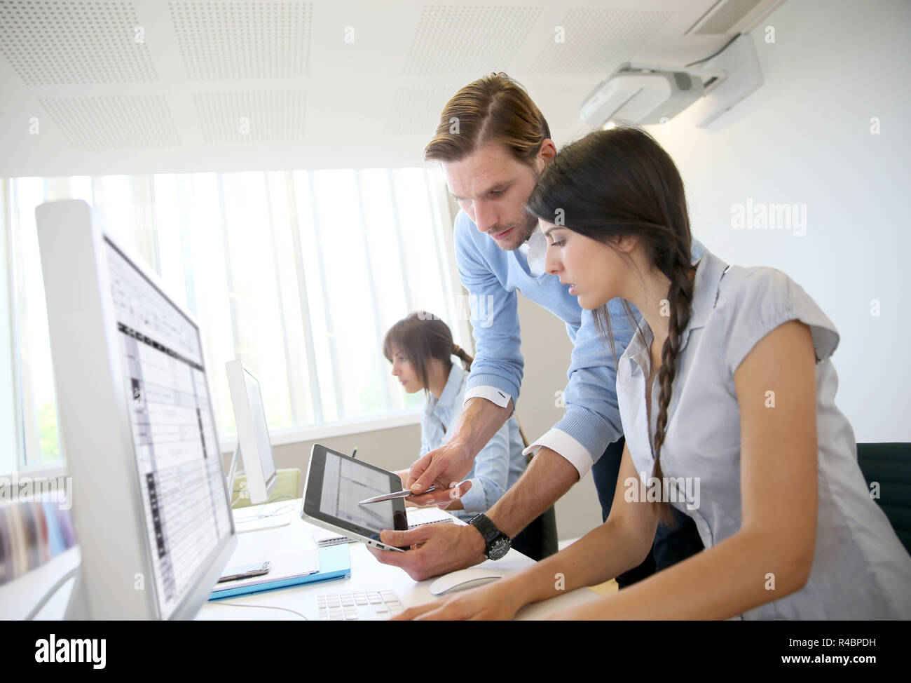 Business people working in office on desktop computer Stock Photo - Alamy