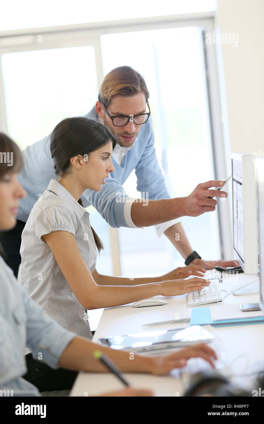 Creative people working in office on computer Stock Photo - Alamy