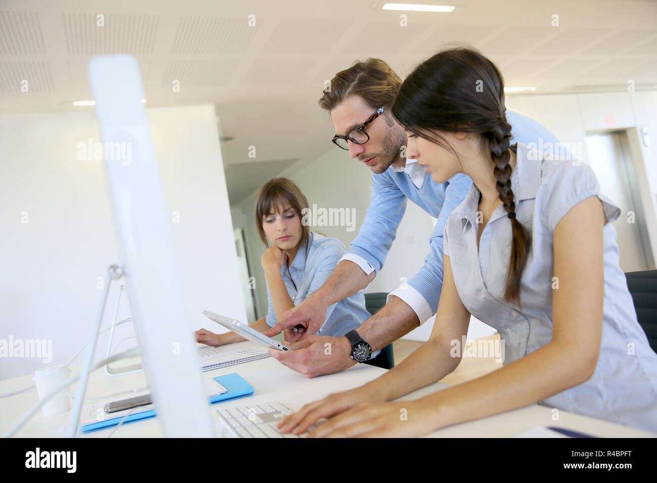 Business people working in office on desktop computer Stock Photo - Alamy