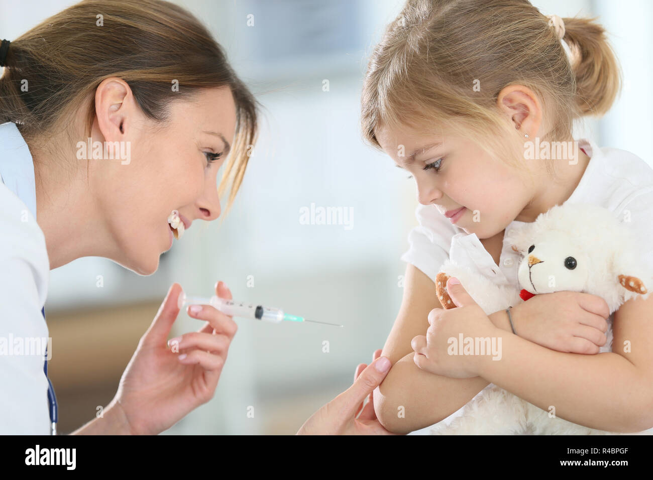 Brave little girl receiving injection in doctor's office Stock Photo ...