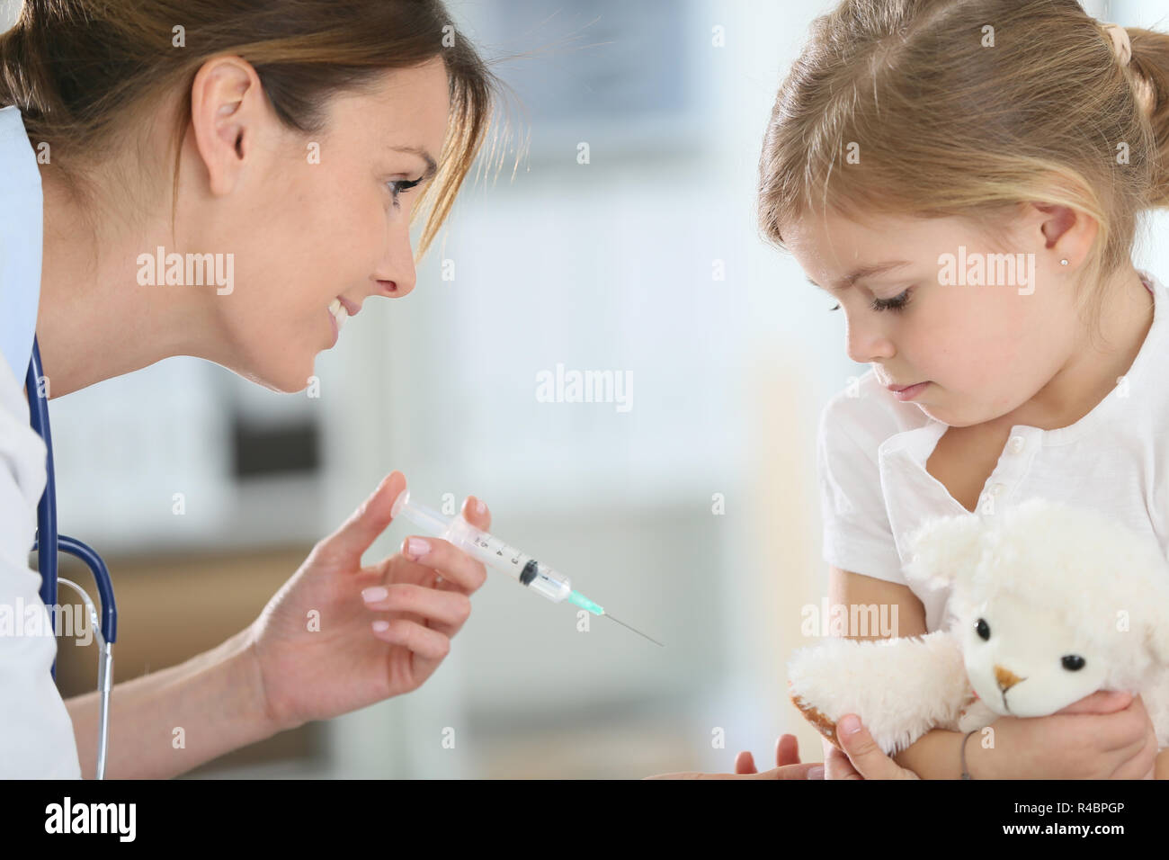 Brave little girl receiving injection in doctor's office Stock Photo ...
