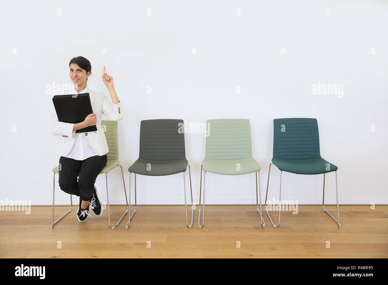 Woman sitting on chair waiting for job interview Stock Photo - Alamy