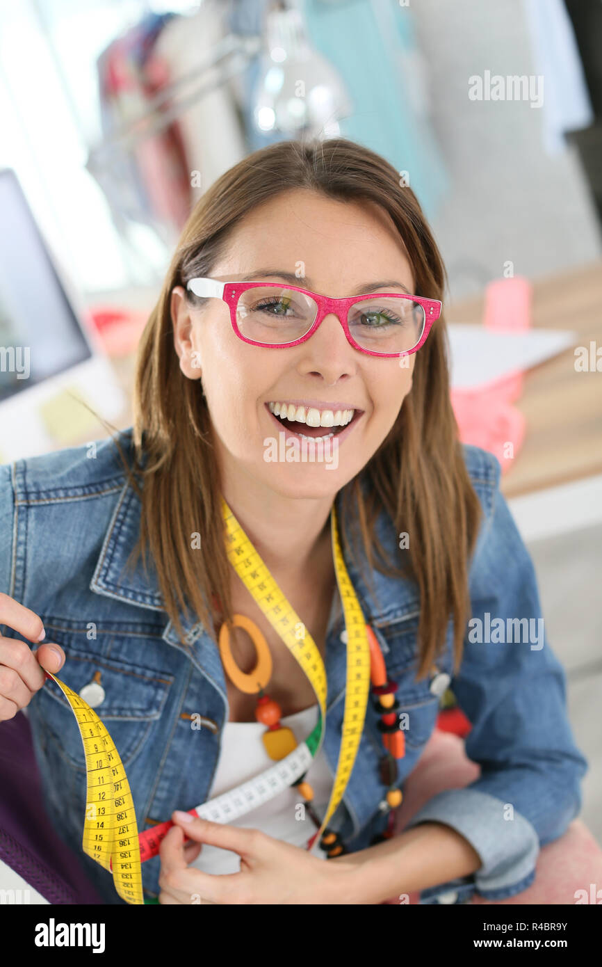 Portrait of cheerful dressmaker in designing studio Stock Photo - Alamy