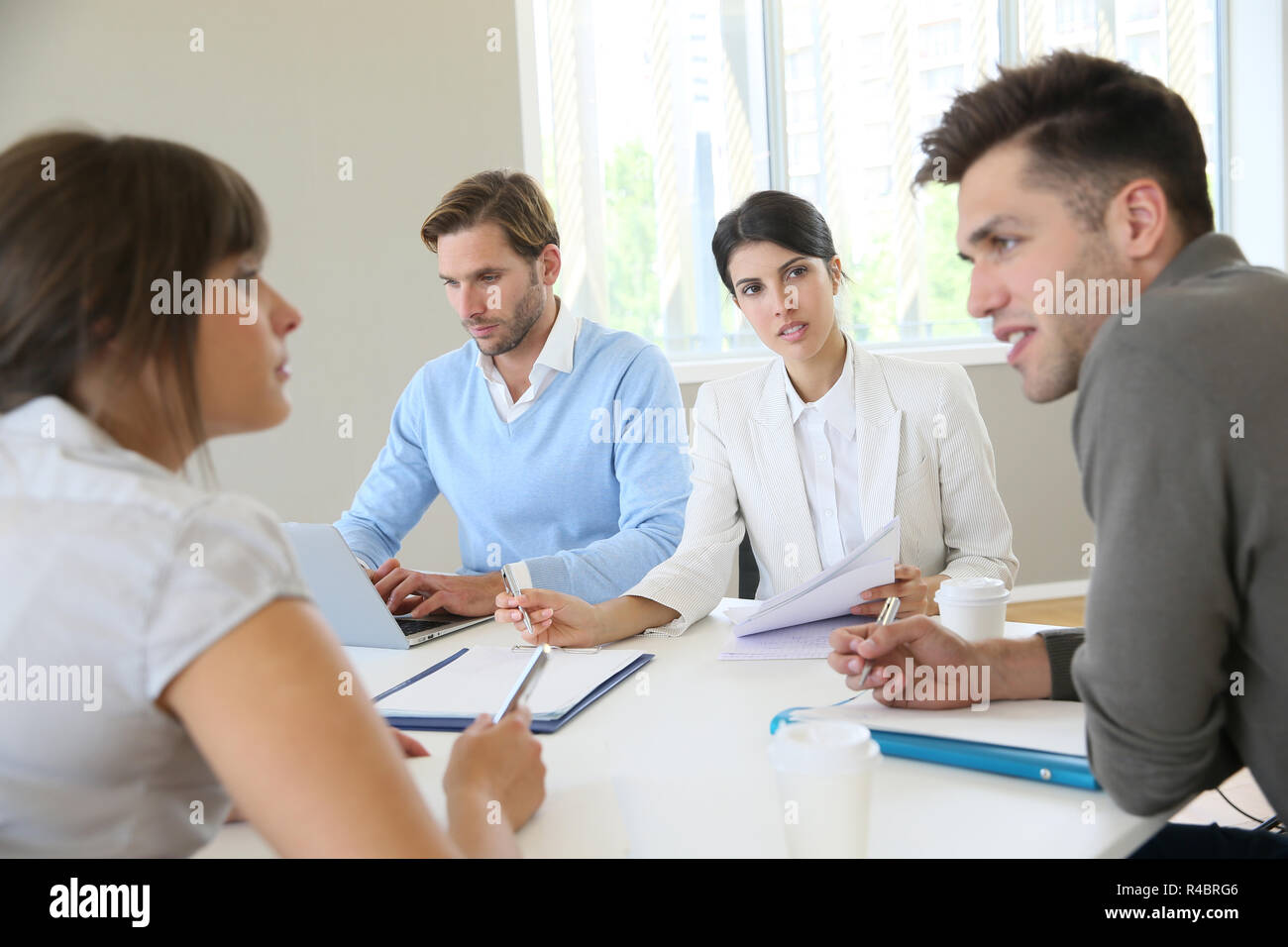 Business people meeting around table in modern space Stock Photo - Alamy