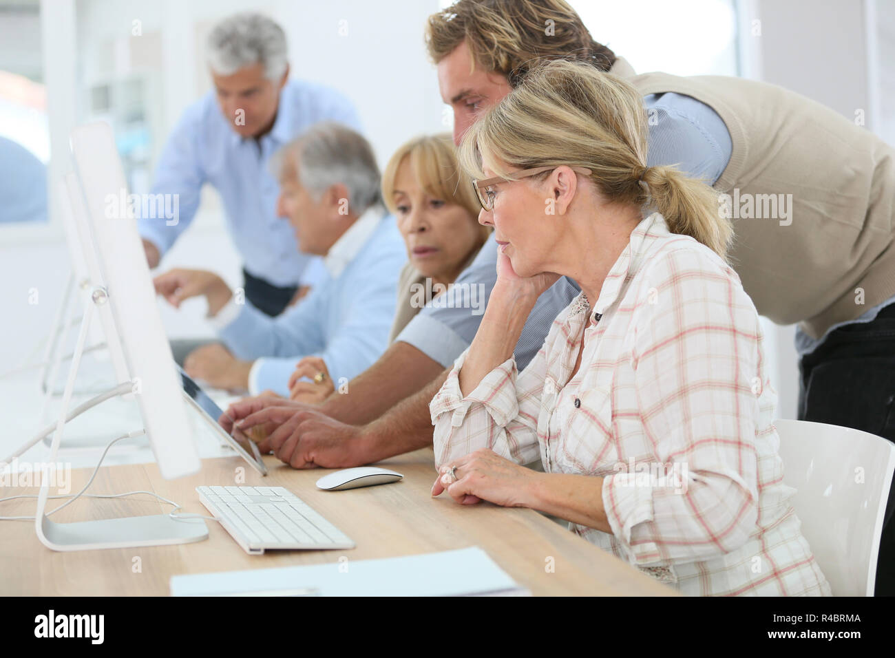 Group of senior people attending computing class Stock Photo - Alamy
