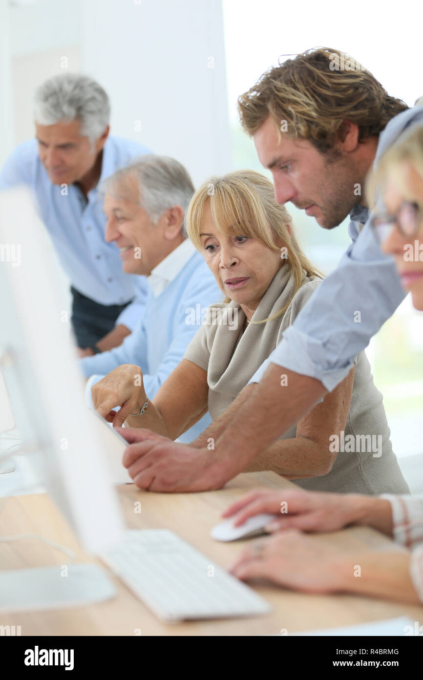 Group of senior people attending computing class Stock Photo - Alamy