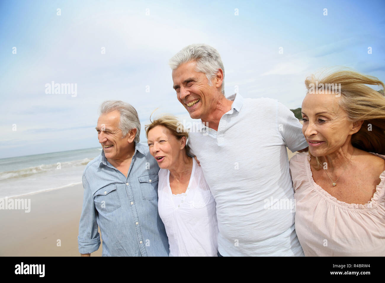 Senior people walking on the beach Stock Photo - Alamy