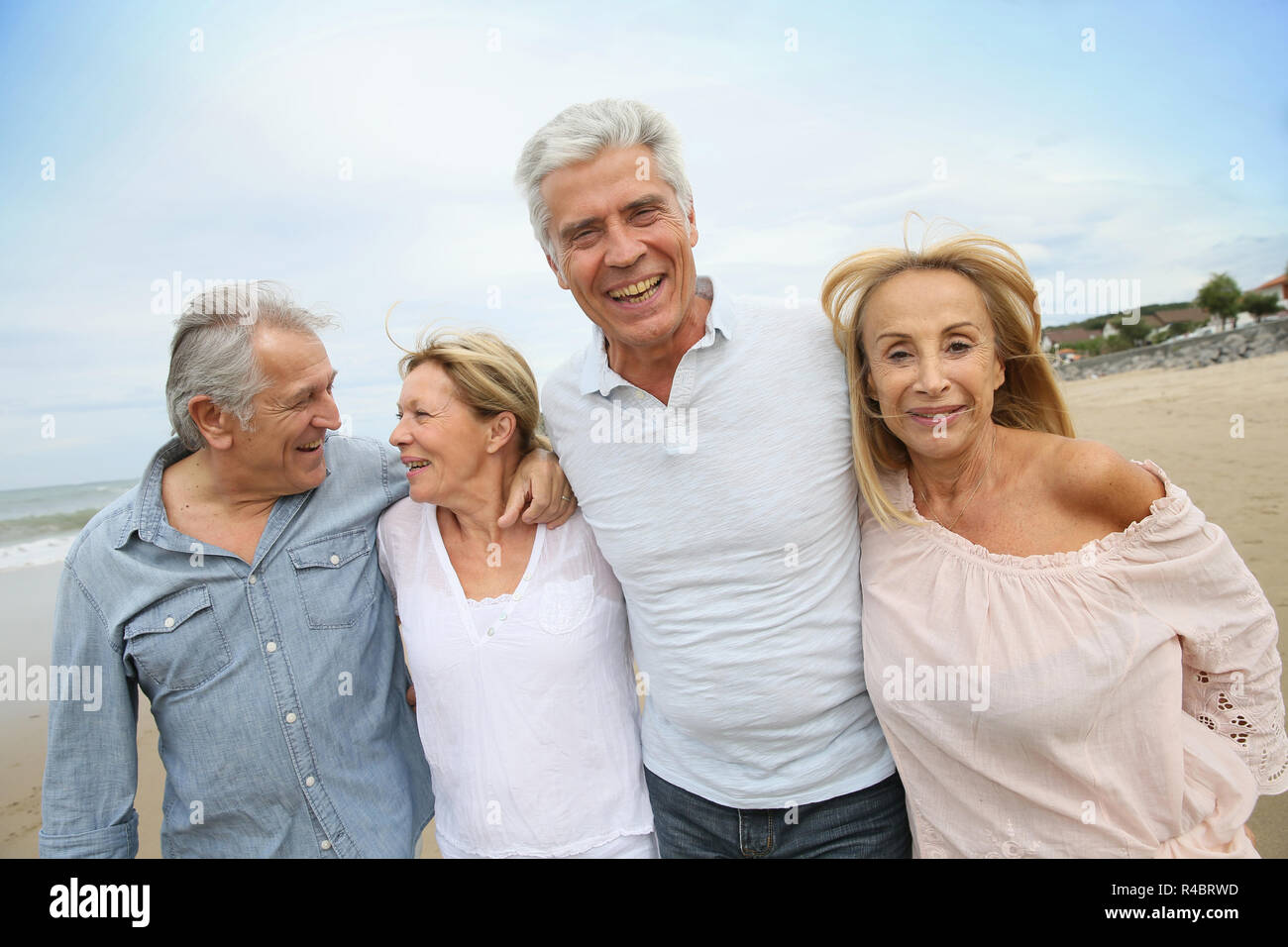 Senior people walking on the beach Stock Photo - Alamy