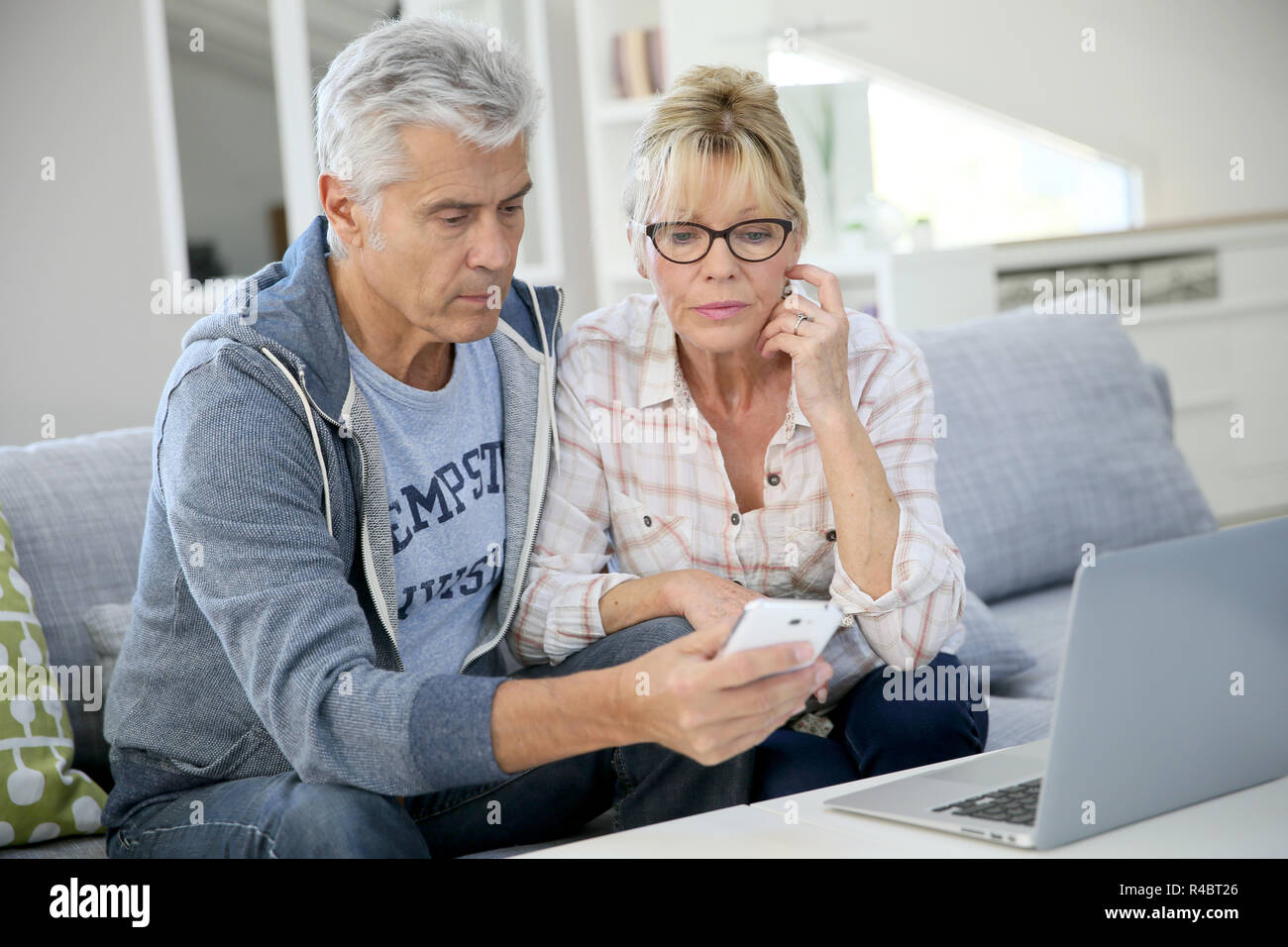 Senior couple at home websurfing on laptop computer Stock Photo - Alamy