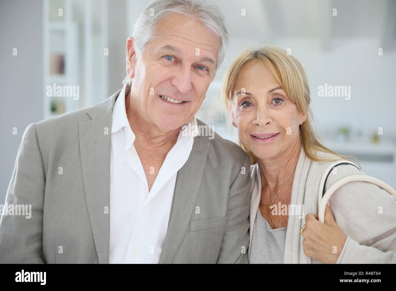 Happy retired couple standing in new home Stock Photo - Alamy