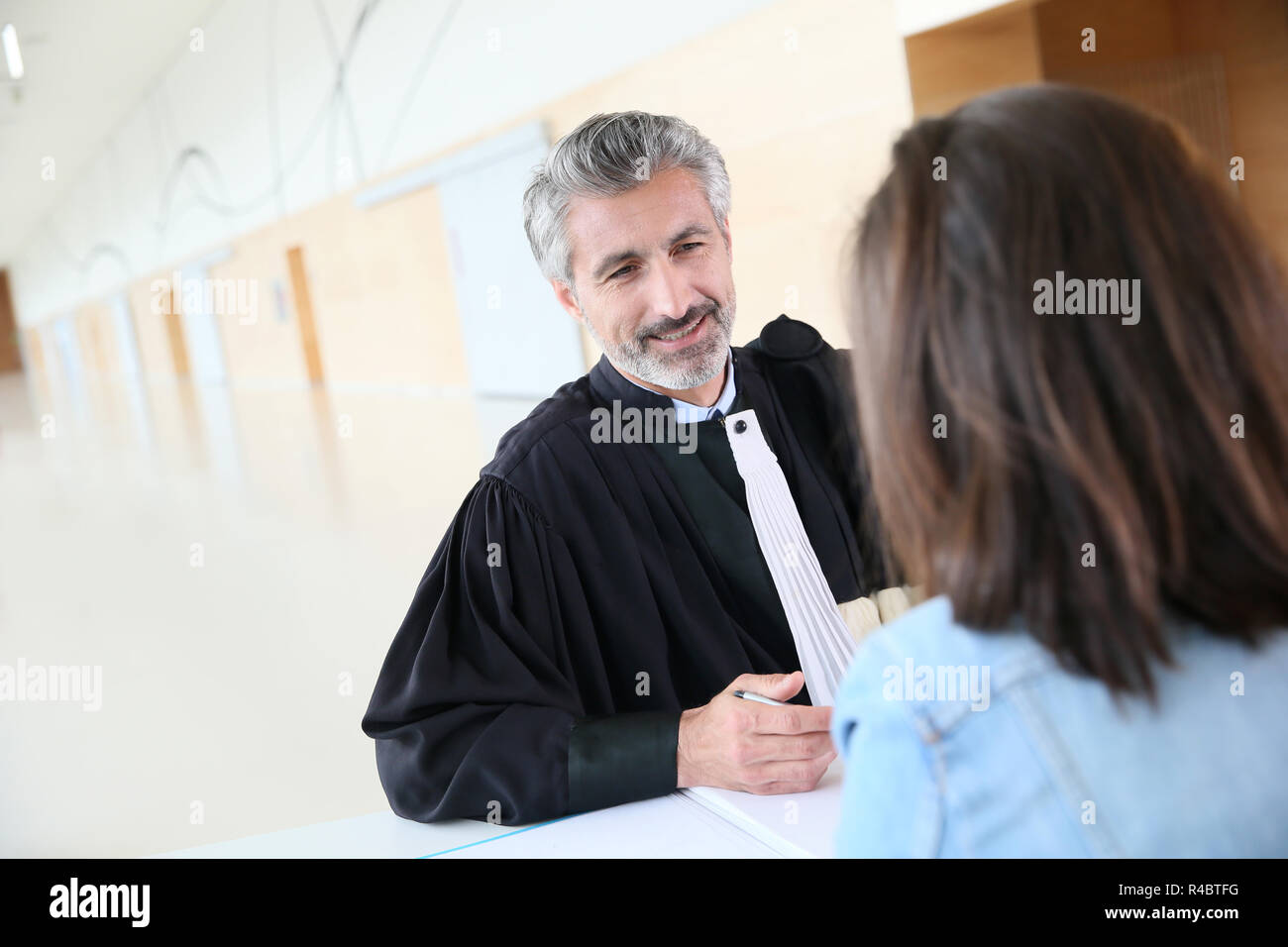 Lawyer meeting client in courthouse before trial Stock Photo - Alamy