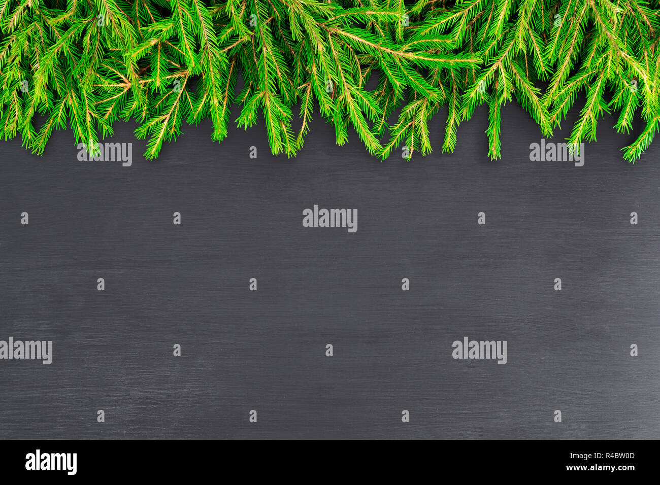 Christmas Border made of natural fir tree branches on black, Flat lay ...