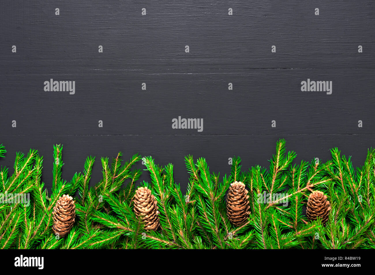 Christmas Border made of natural fir tree branches on black, Flat lay ...