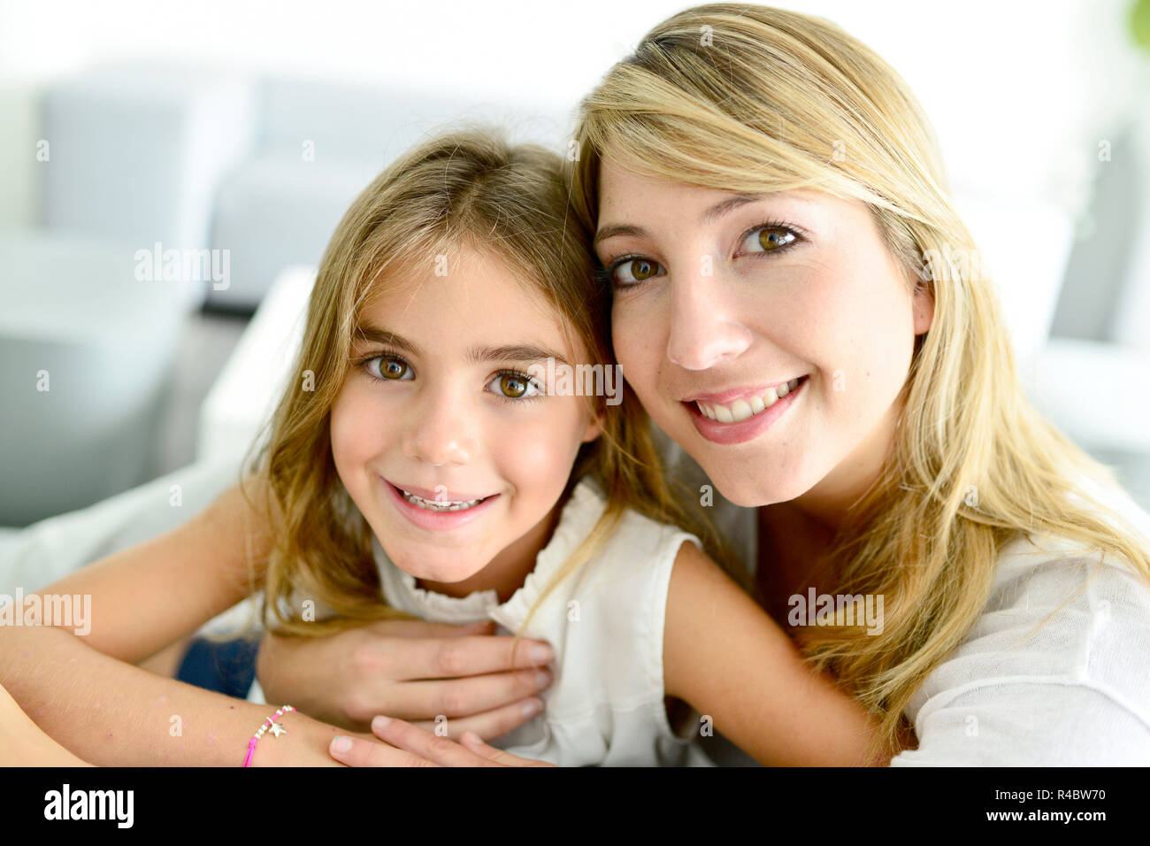 Sweet little girl cuddling with her mom Stock Photo - Alamy