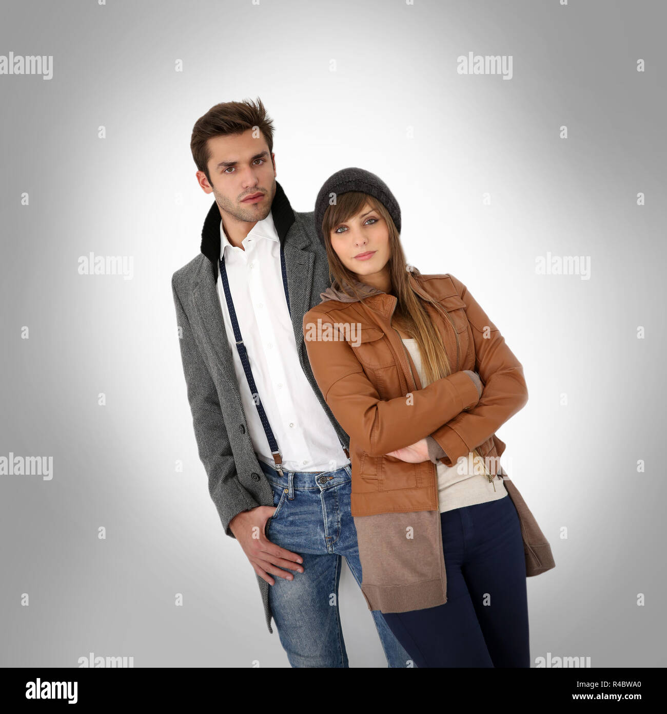 Trendy couple of lovers standing on white background Stock Photo - Alamy