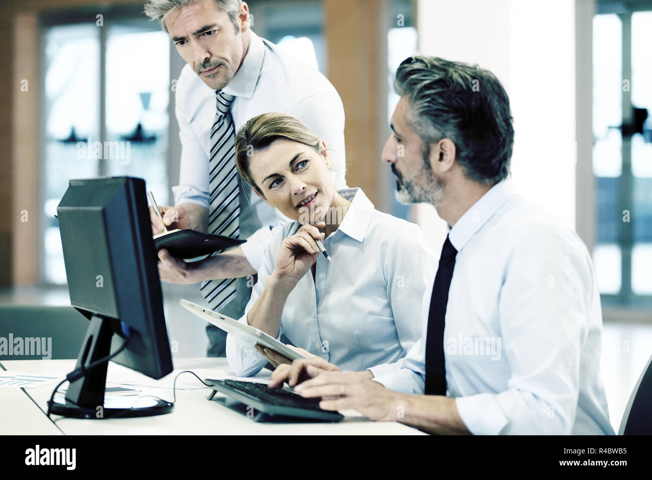 Business team working on project in office Stock Photo - Alamy