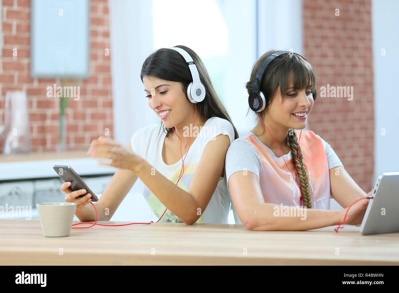 Girl friends connected each one with a different support Stock Photo ...