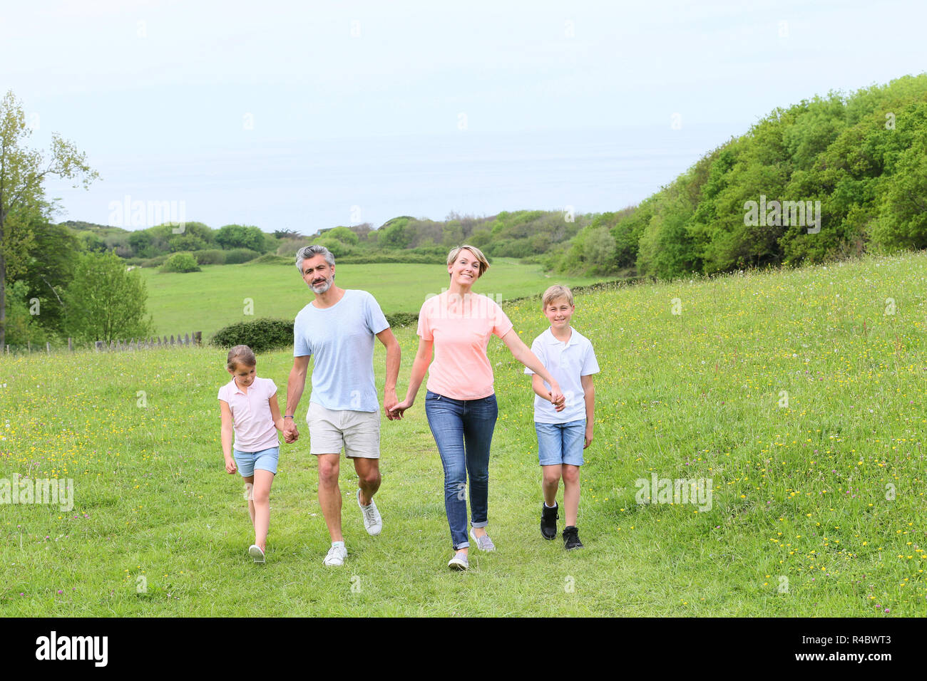 Family walking on country trail during vacation time Stock Photo - Alamy