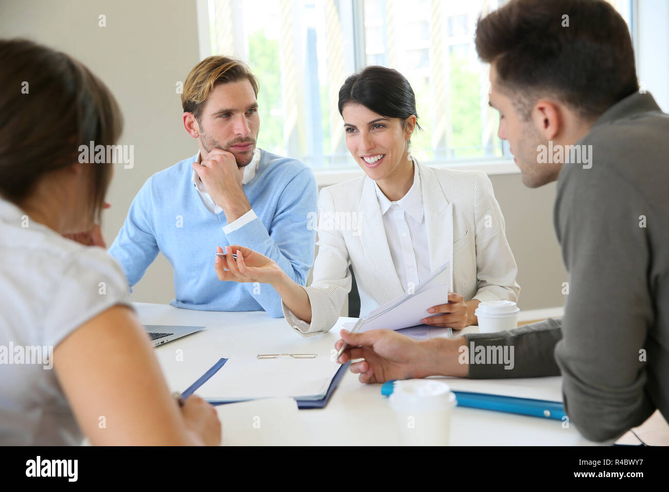 Business people meeting around table in modern space Stock Photo - Alamy